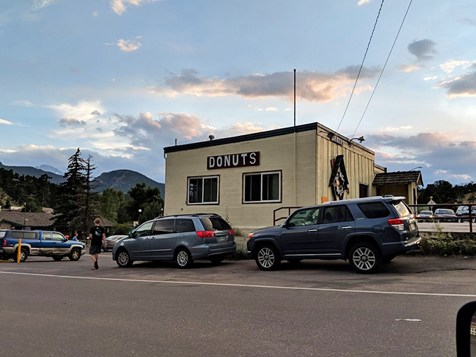 The unassuming exterior of Donut Haus stands like a beacon of sugary hope against the majestic Rocky Mountain backdrop. Sweet treasures await inside.