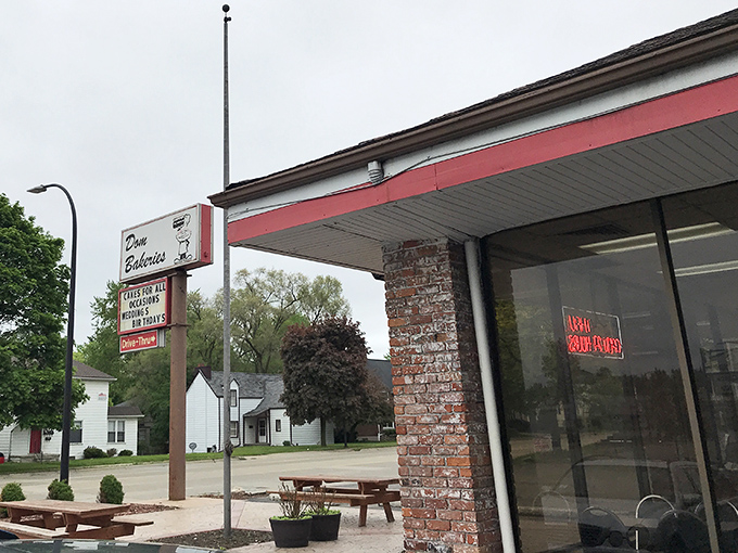 The vintage sign beckons like a lighthouse for the sugar-deprived. Dom Bakeries' retro charm stands strong against fast food uniformity.