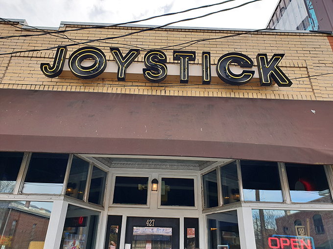 The unassuming brick exterior of Joystick Gamebar beckons with retro neon promise – like finding a secret level in your favorite childhood game.
