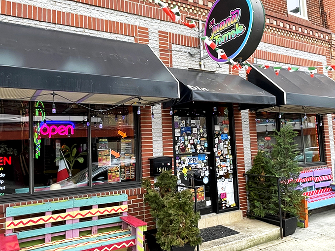 The colorful storefront of Juana Tamale beckons like a fiesta waiting to happen. Mexican flags and vibrant signage promise authentic flavors on East Passyunk Avenue.