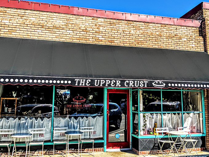 The unassuming storefront of The Upper Crust beckons like a siren song to pie lovers. That navy awning and bright red door are basically saying, "Get in here, hungry person!"