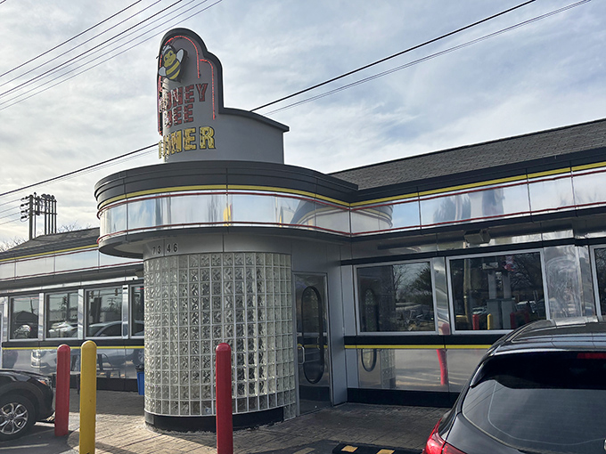 The classic mid-century silhouette of Honey Bee Diner stands proudly on Ritchie Highway, its cheerful bee mascot promising sweet comfort inside.