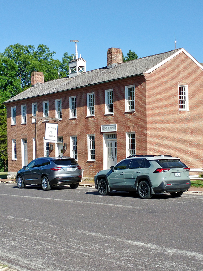 The historic red brick exterior of J. Huston Tavern stands proudly in Arrow Rock, a time capsule of frontier hospitality since 1834. 