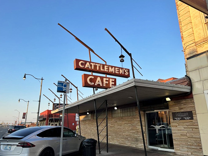 The brick facade of Cattlemen's stands proudly in Oklahoma City's Stockyards, a carnivore's lighthouse beckoning hungry travelers through decades of beef-loving history.