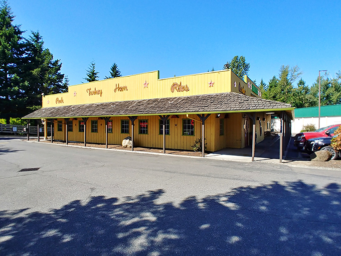 The yellow facade of Buster's stands like a Texas mirage in Oregon, promising smoked meat salvation to weary travelers.