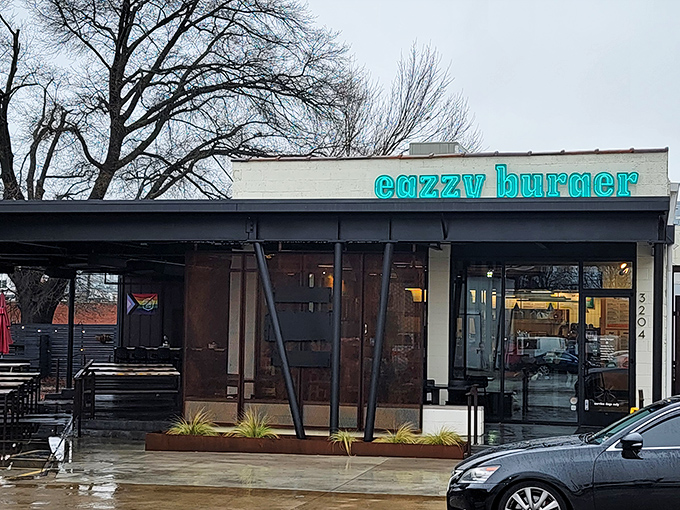 That turquoise neon sign against the white building isn't just a beacon for hungry travelers&mdash;it's a promise of burger nirvana waiting inside.