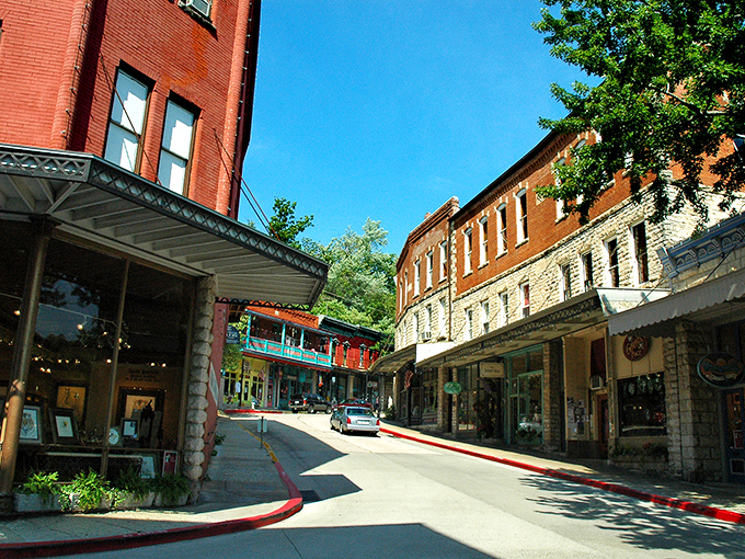 Downtown Eureka Springs curves like a Victorian dream, where red brick buildings and historic hotels create a postcard-perfect scene that defies modern architectural monotony.