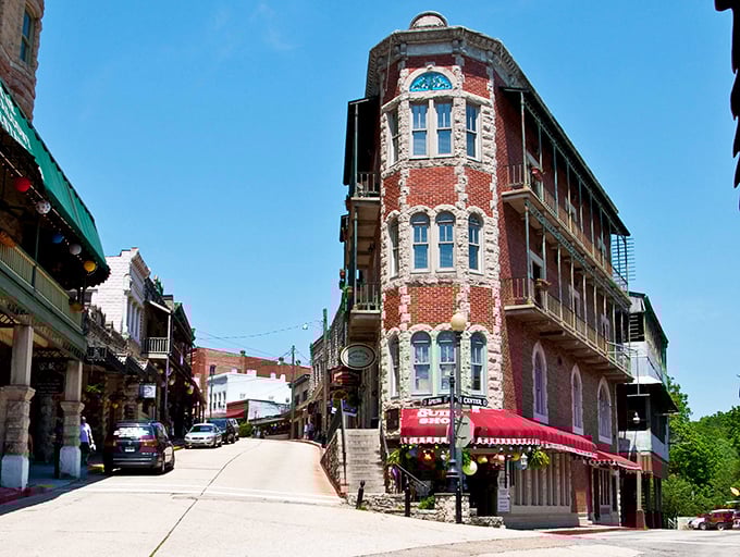 Downtown Eureka Springs curves like a Victorian dream, where red brick buildings and historic hotels create a postcard-perfect scene that defies modern architectural monotony.
