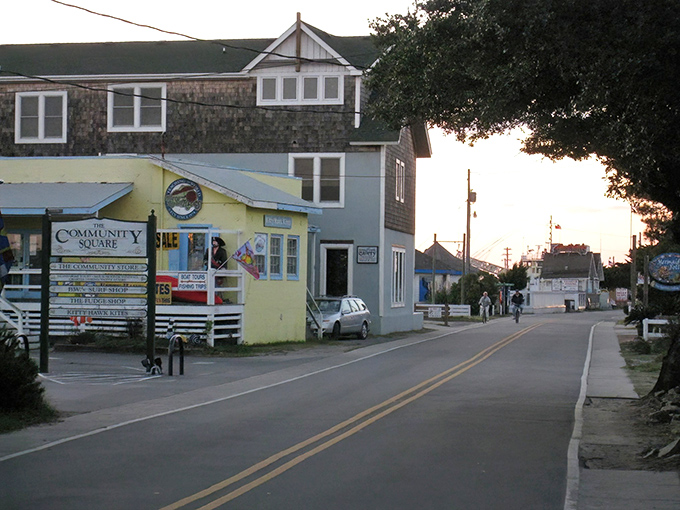 Ocracoke's main street at dusk feels like stepping into a storybook &ndash; where every shop has a tale and string lights guide your way home.