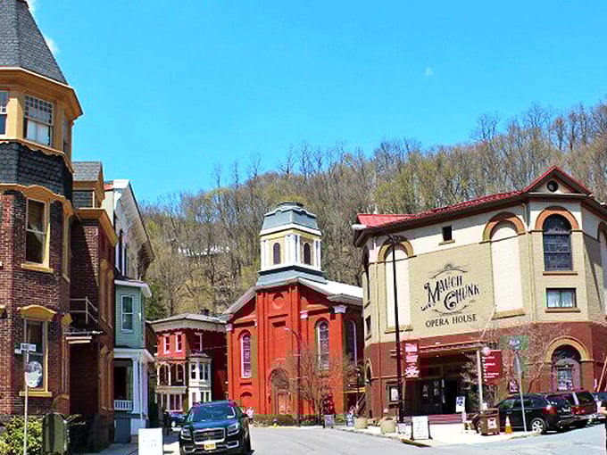Victorian charm meets mountain majesty in downtown Jim Thorpe, where the Mauch Chunk Opera House stands as a cultural cornerstone against a backdrop of forested hills.