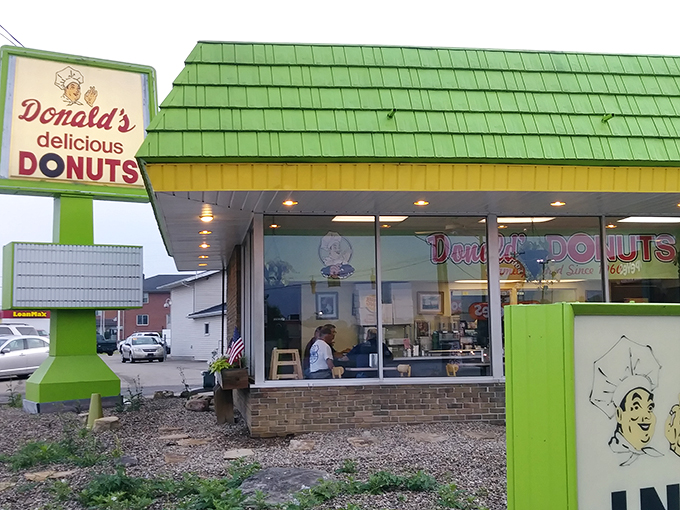 The mint-green shingled roof beckons like a sugar-coated lighthouse, guiding hungry travelers to this unassuming temple of fried dough excellence.