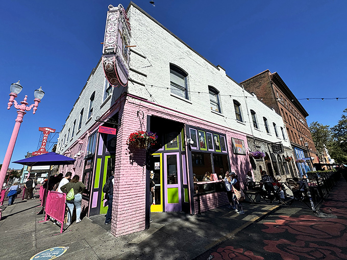 The corner where calories don't count. Voodoo Doughnut's iconic pink building stands like a sugar-powered beacon in downtown Portland, drawing pilgrims from across the globe. 