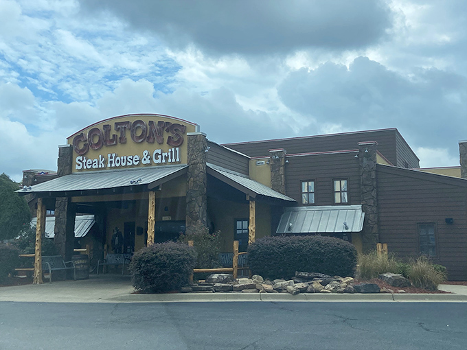 The rustic stone facade of Colton's stands like a carnivore's lighthouse, beckoning hungry travelers with promises of perfectly grilled protein.