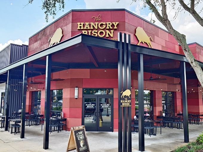 The distinctive red facade of The Hangry Bison stands out in Winter Park like a beacon for burger enthusiasts seeking meaty salvation.