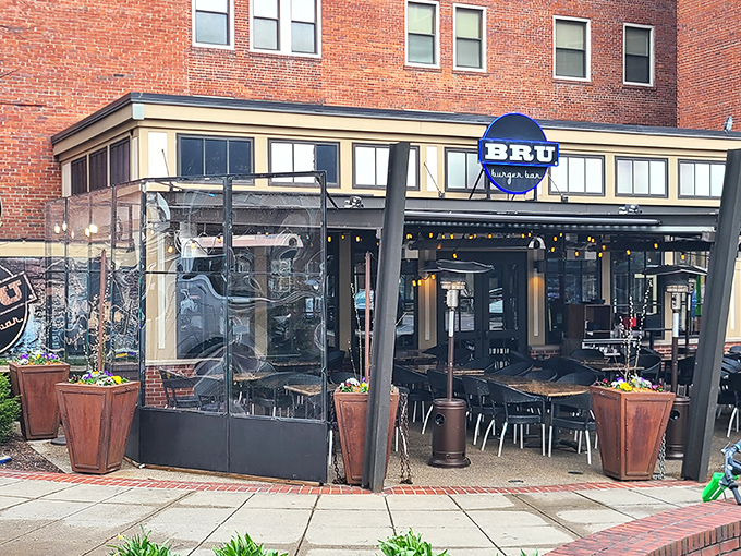The iconic blue BRU sign beckons hungry patrons like a burger lighthouse on Mass Ave's brick-lined shores. Come for the burgers, stay for the patio vibes.