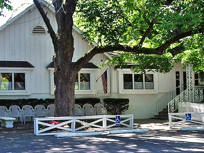 The unassuming white clapboard exterior of Hollyhock Hill stands like a time capsule of Midwestern hospitality, promising comfort before you even step inside.
