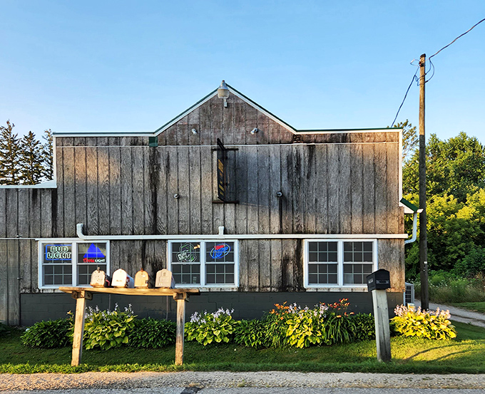 The weathered wooden exterior of Gunder Roadhouse stands as a beacon for burger pilgrims, its simple sign promising legendary satisfaction inside.