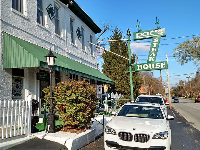 The unassuming green exterior of Pat's Steakhouse hides culinary greatness like a superhero's secret identity. That modest sign has guided hungry Louisvillians for generations.