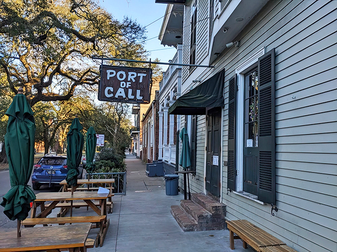 The unassuming exterior hides culinary greatness, with Port of Call's wooden sign swinging gently like a maritime invitation to burger paradise.