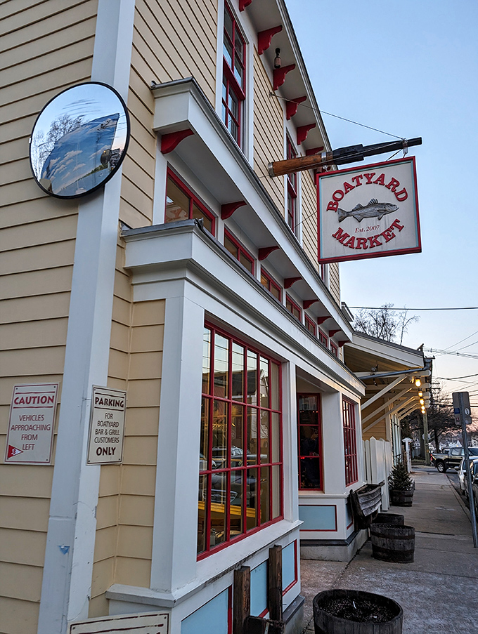 The cheerful yellow exterior of Boatyard Bar & Grill stands like a beacon for seafood lovers, promising maritime delights within its nautical embrace.