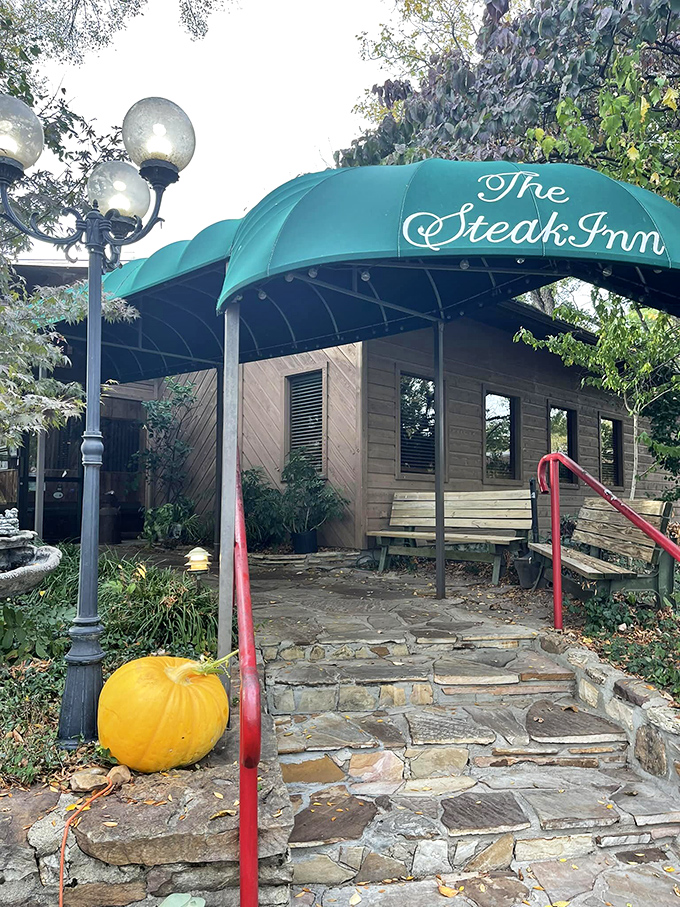 The rustic cabin exterior of The Steak Inn emerges from the Ozark forest like a carnivore's mirage, promising chargrilled treasures within. 