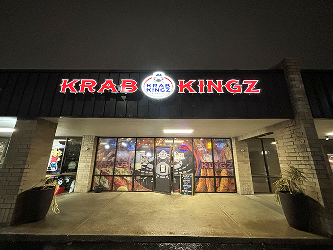 The bright red Krab Kingz sign glows like a beacon in the night, promising seafood treasures within this unassuming strip mall location.