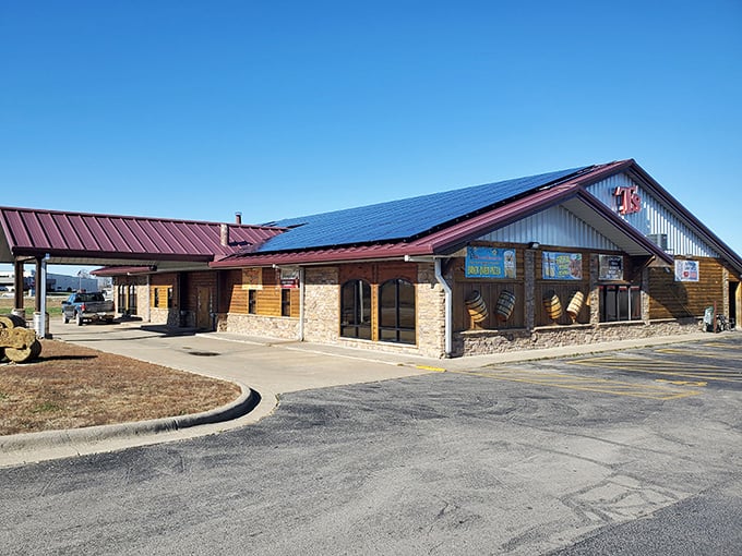 The log cabin exterior of T's Redneck Steakhouse glows with warm invitation as dusk settles, promising carnivorous delights within those rustic walls. 