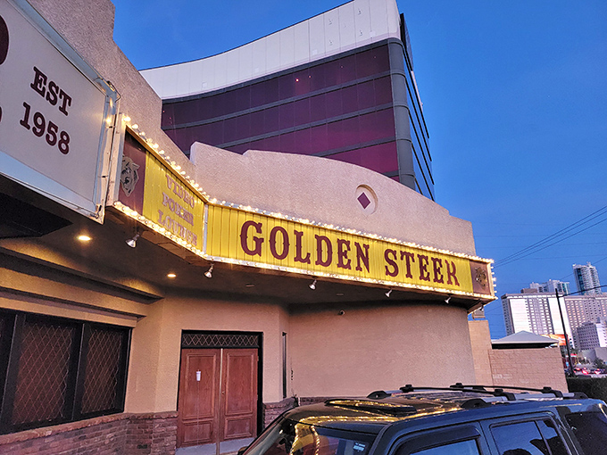 The unassuming exterior of Golden Steer stands like a time capsule amid Vegas glitz, its vintage yellow sign promising authentic experiences inside.