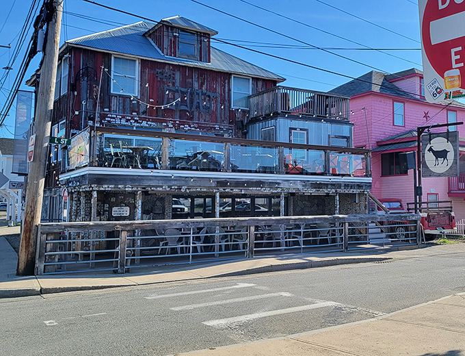 The weathered wooden exterior of The Goat stands proudly against Hampton's skyline, like a delicious pirate ship that decided to drop anchor and serve burgers instead.