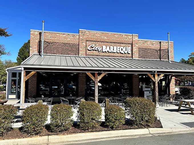The brick fortress of flavor stands proud with its metal roof and welcoming red umbrellas&mdash;a barbecue beacon calling hungry travelers home.