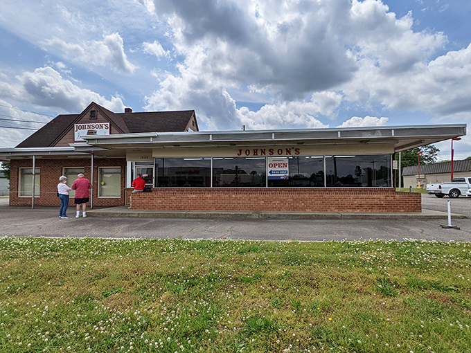 The unassuming brick exterior of Johnson's Drive-In has welcomed burger pilgrims since 1946, proving that greatness rarely needs fancy packaging.