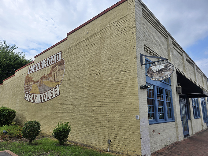 The unassuming yellow brick exterior of Plank Road Steak House hides culinary treasures within, like a delicious secret waiting to be discovered.