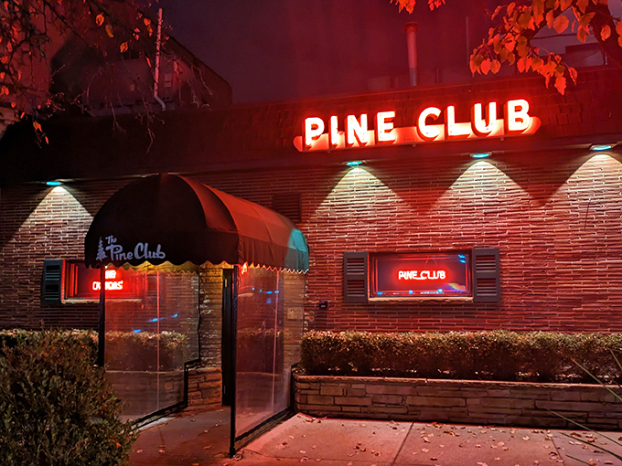The iconic green awning and brick facade of The Pine Club stands as Dayton's temple to timeless steakhouse tradition.