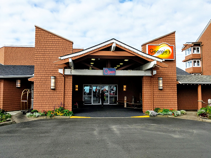 Cedar-shingled charm meets coastal elegance at Georgie's entrance, where the promise of seafood treasures awaits just beyond those welcoming doors.