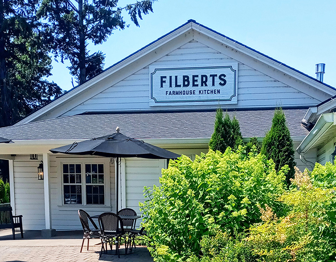 The classic white farmhouse exterior of Filberts beckons like an old friend, promising comfort food that'll make you forget your troubles at the door. 