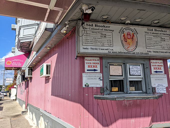 The neon-pink beacon of Sid Booker's illuminates the Philadelphia night like a seafood lighthouse, calling hungry travelers home to shrimp paradise.