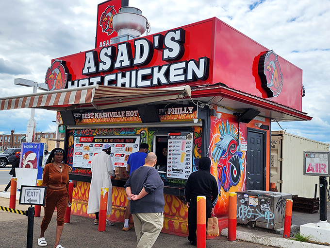 Asad's vibrant exterior stands out like a spicy beacon of hope, complete with Philadelphia sports murals and those distinctive orange bollards guarding the perimeter.