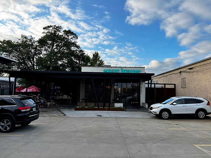 That turquoise neon sign against the white building isn't just a beacon for hungry travelers&mdash;it's a promise of burger nirvana waiting inside.