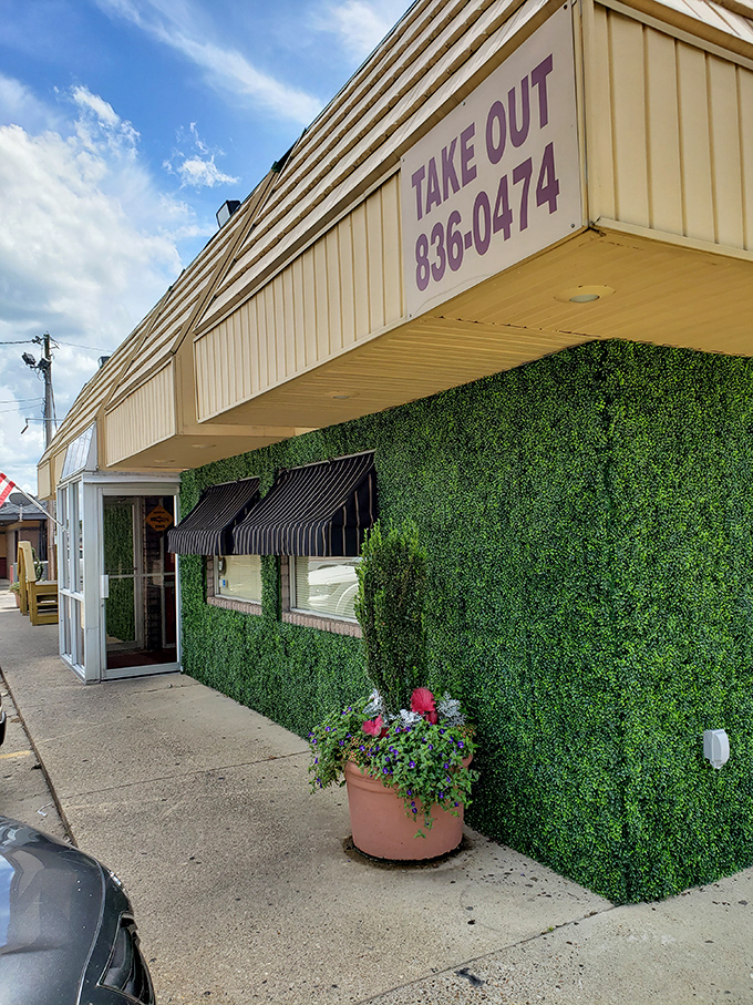The unassuming exterior of Woods Place, with its distinctive green trim and simple sign, stands as Camden's culinary beacon for catfish aficionados.