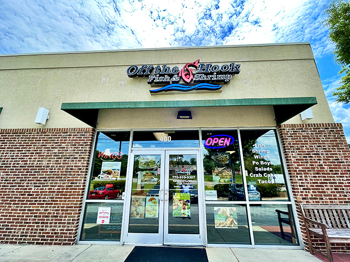 The neon glow of Off The Hook beckons like a lighthouse for the seafood-starved, promising fried treasures within its unassuming brick walls.