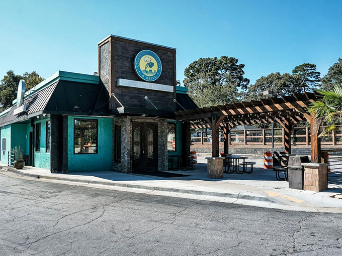 The teal and stone exterior beckons like a seafood lighthouse in Atlanta's urban landscape. That wooden pergola practically whispers "come sit awhile."