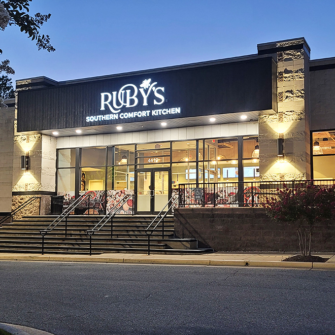 Ruby's glows like a beacon of Southern promise against the night sky, beckoning hungry travelers with its sleek exterior and warm lighting.