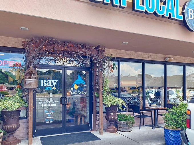 The coastal charm starts before you even step inside. Bay Local's entrance, adorned with lush greenery and rustic touches, promises a feast beyond the ordinary.