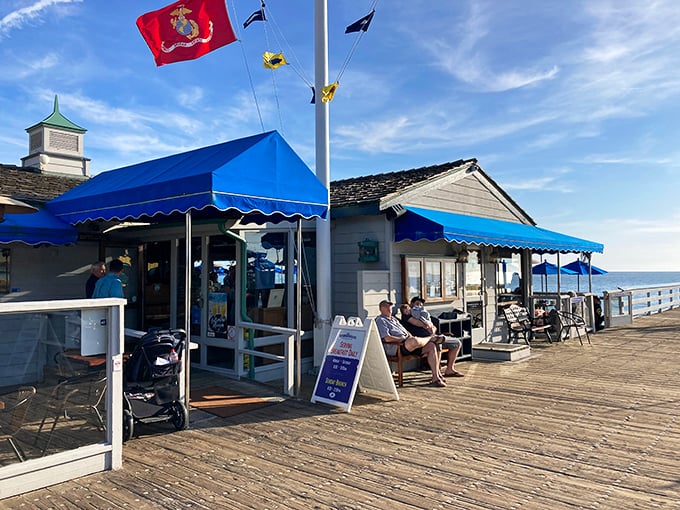 The blue awnings of The Fisherman's Restaurant pop against the San Clemente sky, beckoning hungry visitors like a maritime mirage on the historic pier.