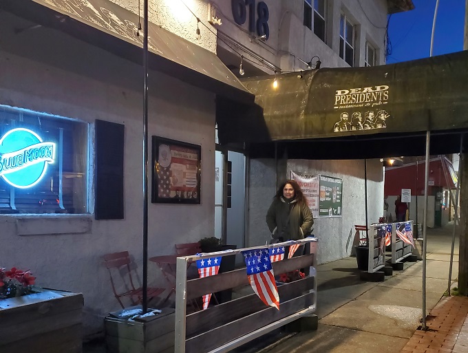 The iconic Dead Presidents sign welcomes patrons with silhouettes of Lincoln, Jefferson, Roosevelt, and Washington &ndash; history class never looked this appetizing.