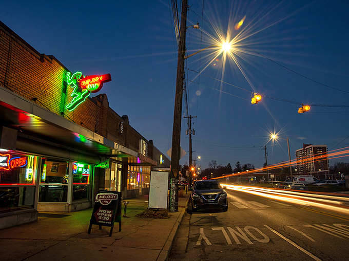 The neon glow of Melody Inn beckons like a lighthouse for music lovers, with its unassuming exterior hiding decades of Indianapolis rock history.