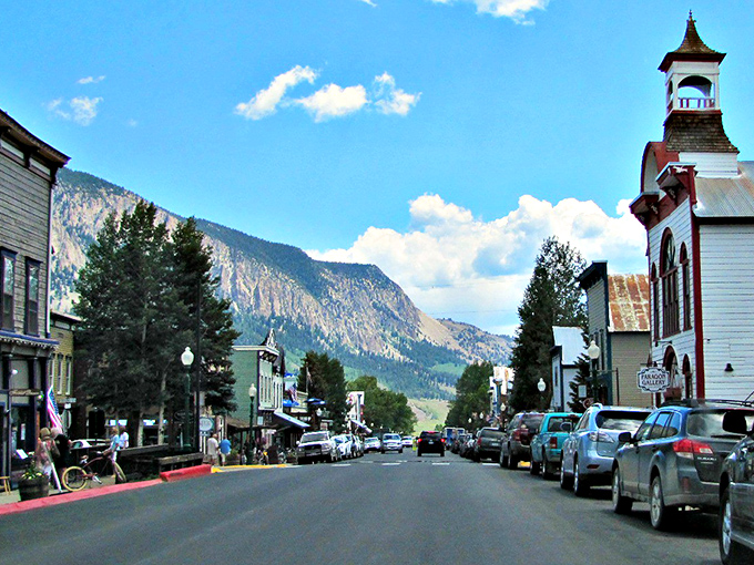 Elk Avenue stretches toward mountain majesty like a Western movie set come to life. Victorian charm meets rugged peaks in perfect harmony.