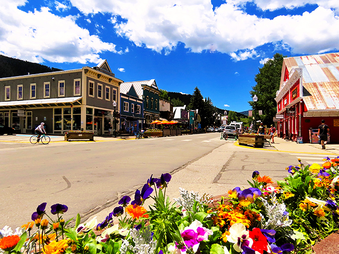 Elk Avenue stretches toward mountain majesty like a Western movie set come to life. Victorian charm meets rugged peaks in perfect harmony.