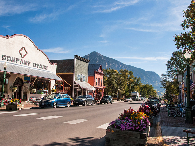 Elk Avenue stretches toward mountain majesty like a Western movie set come to life. Victorian charm meets rugged peaks in perfect harmony.
