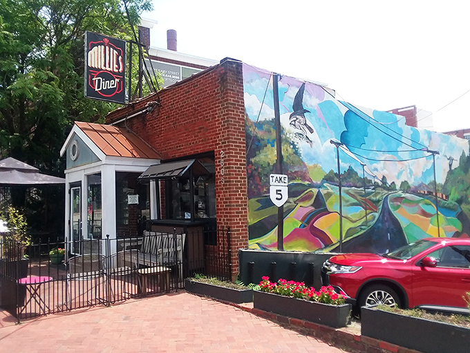 The unassuming brick exterior of Millie's Diner belies the culinary magic happening inside. That colorful mural isn't just decoration&mdash;it's a preview of the vibrant flavors awaiting you.
